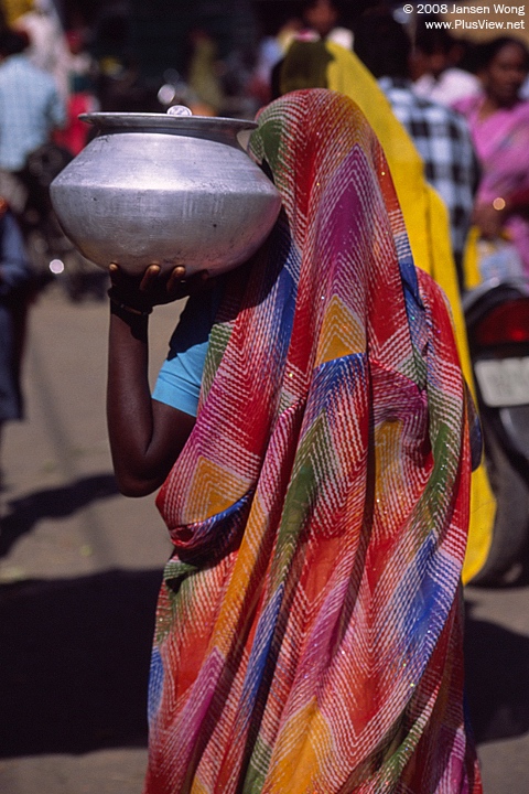 Woman carrying a pot of water - India